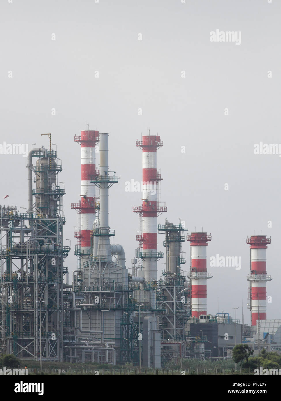Oil refinery chimneys and towers between fog Stock Photo - Alamy