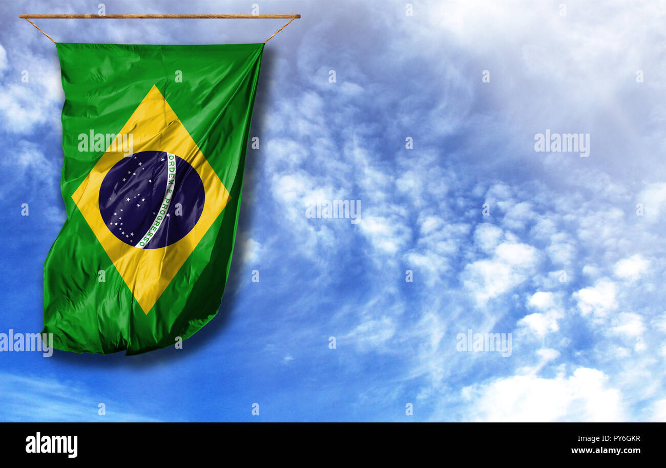 Flag of Brazil. Vertical flag, against blue sky with place for your ...