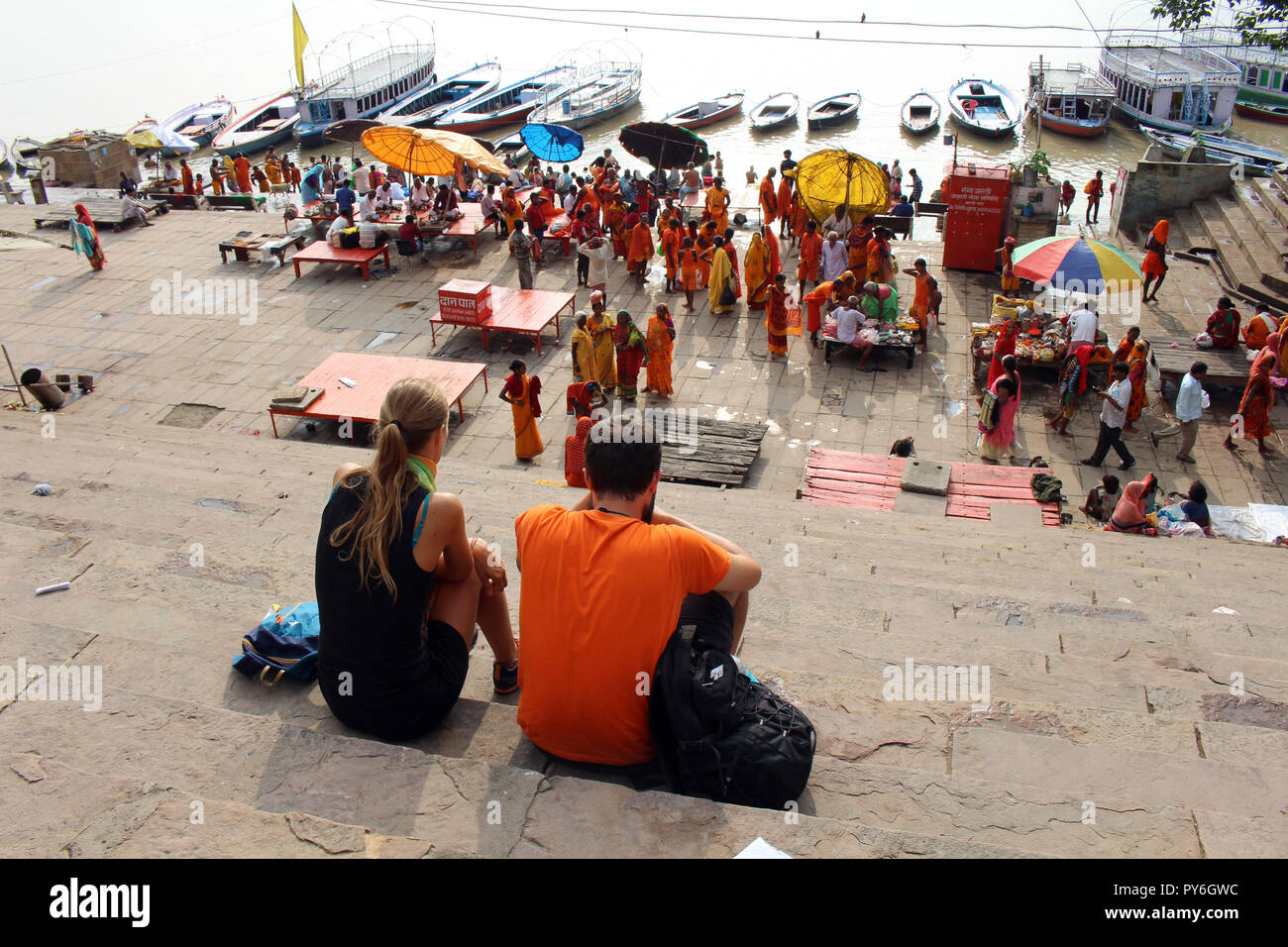 Translation: Tourists watching local people busy preparing rituals at ...