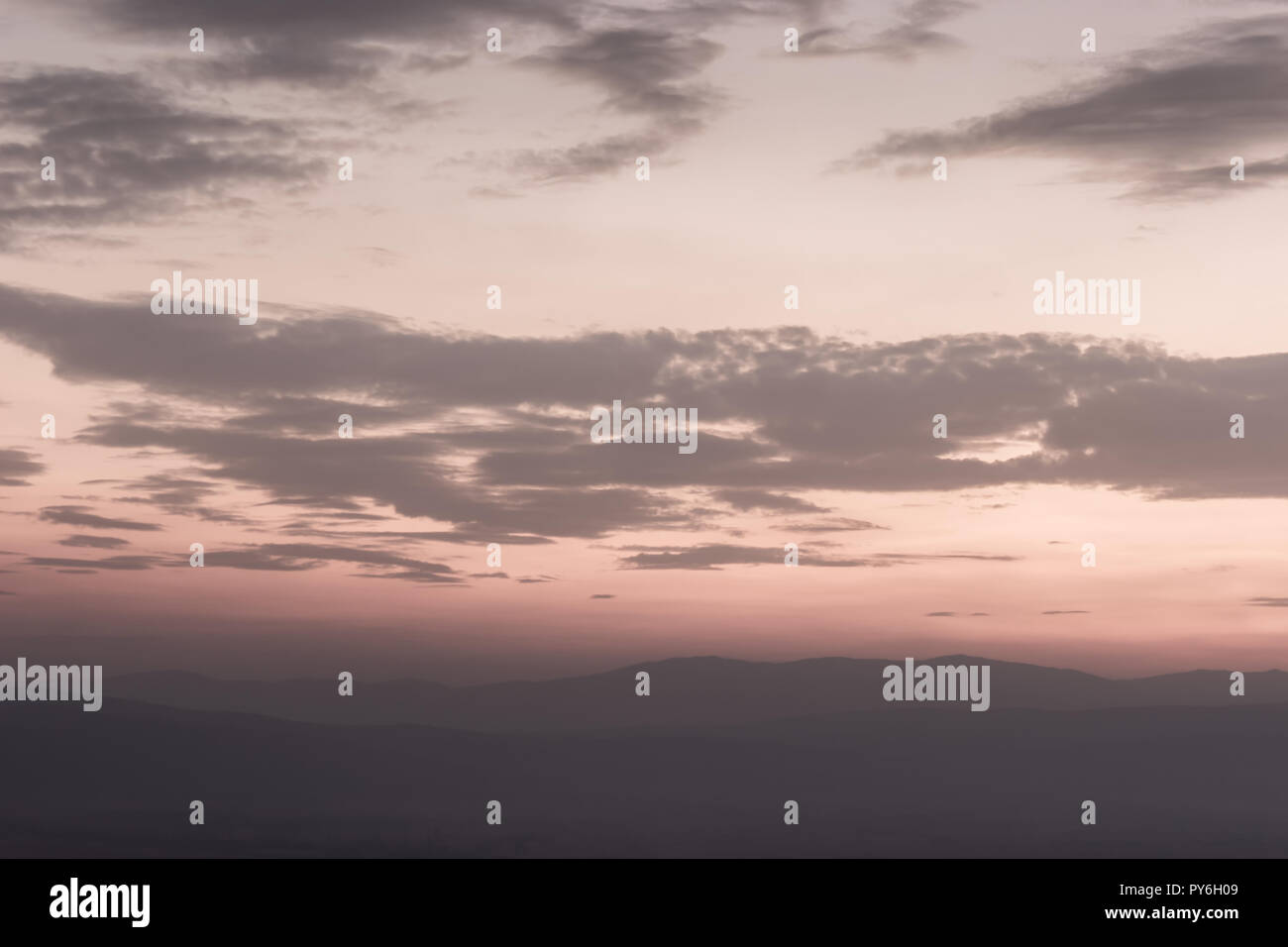 Muted, desatureted sunset sky above dreamy, misty, soft horizon ...