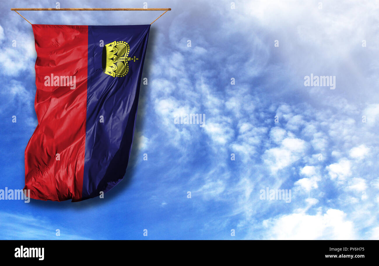 Flag of Liechtenstein. Vertical flag, against blue sky with place for ...