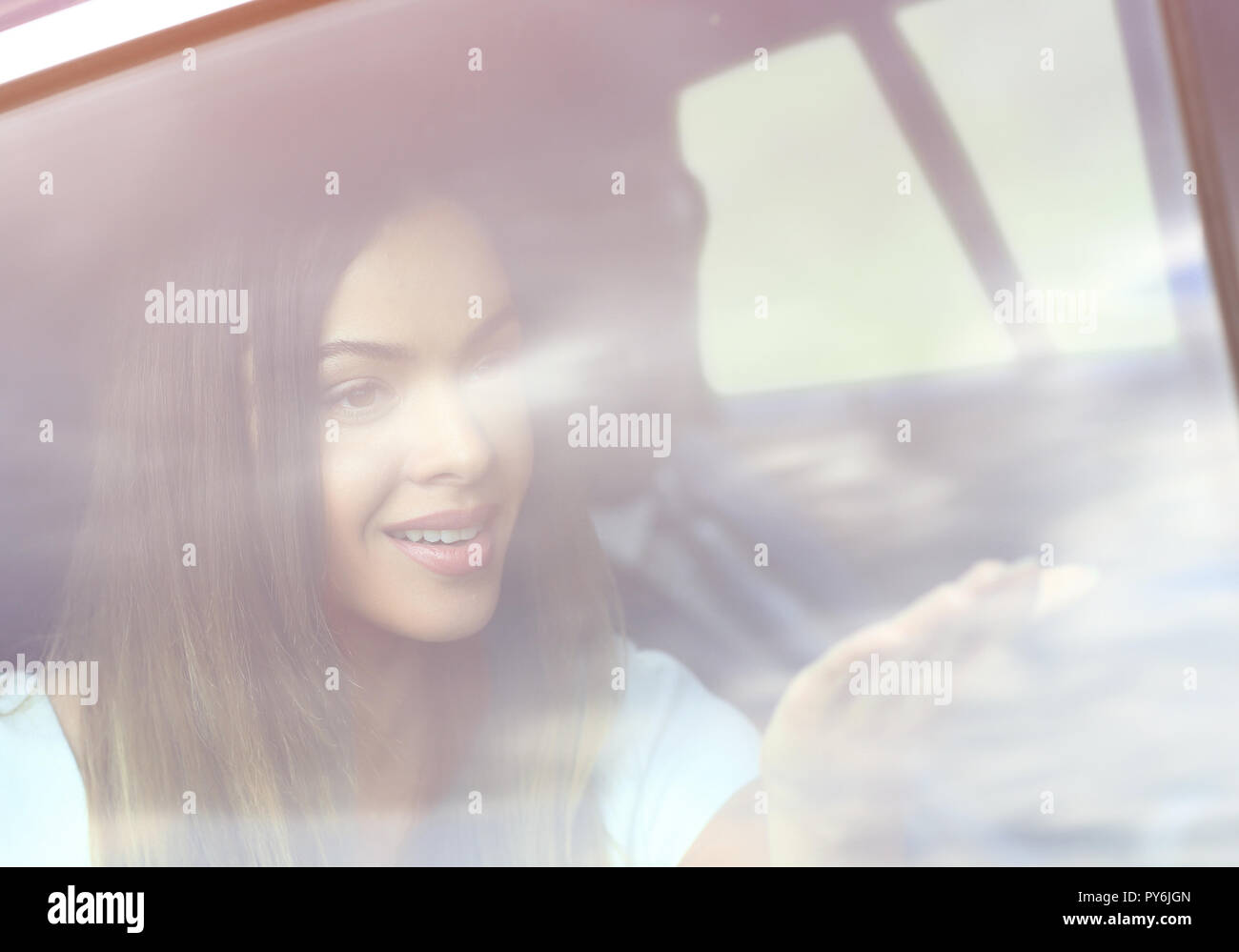 young woman portrait in the car behind the window Stock Photo - Alamy