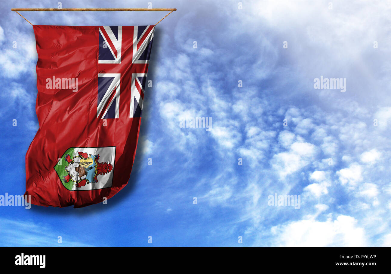 Flag of Bermuda Islands. Vertical flag, against blue sky with place for ...