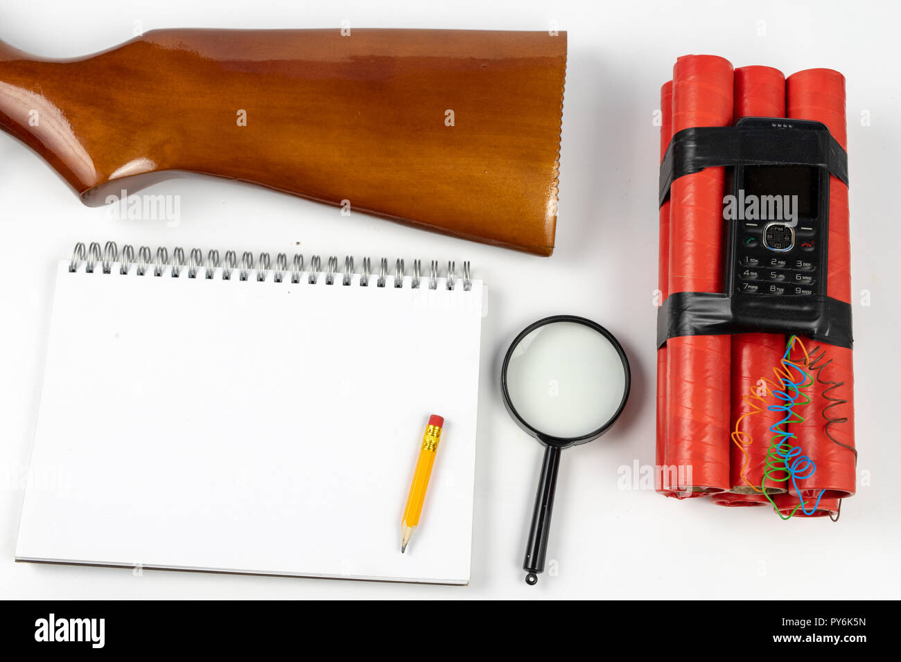 A notepad for making notes and a pencil on a table with a firearm ...
