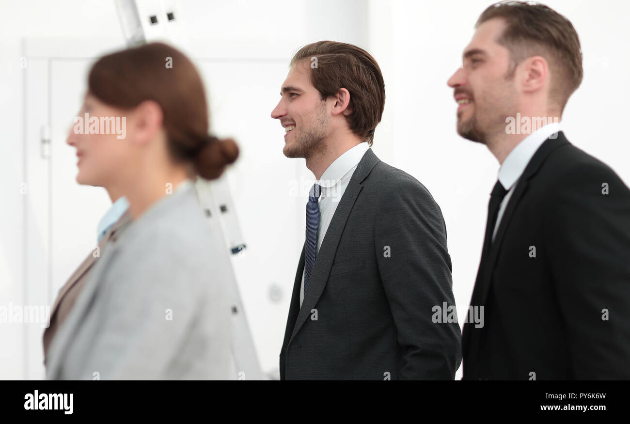 side view.a group of successful business people standing together Stock ...