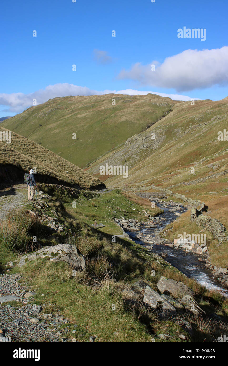 Solitary male fellwalker on track by Hayeswater Gill in the English ...
