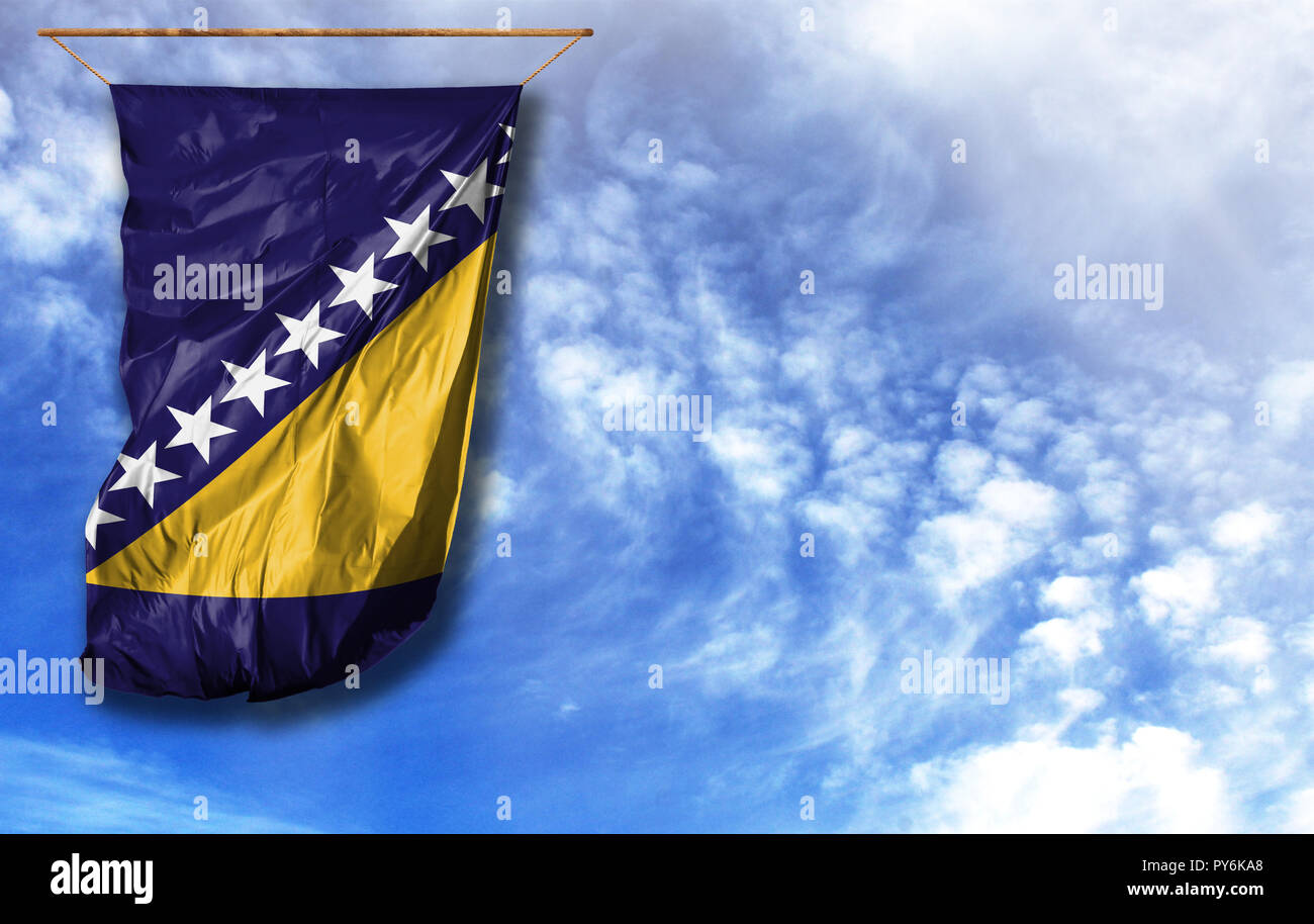 Flag of Bosnia and Herzegovina. Vertical flag, against blue sky with ...