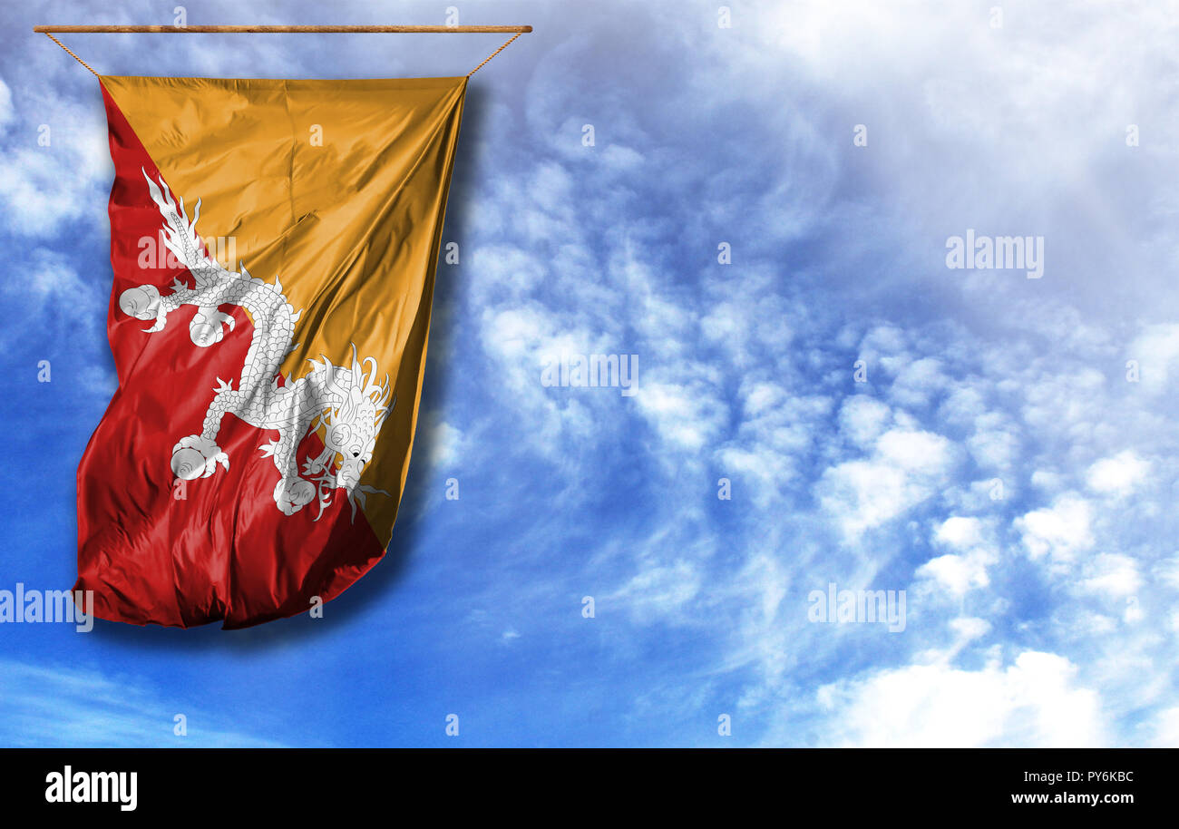 Flag of Butane. Vertical flag, against blue sky with place for your ...