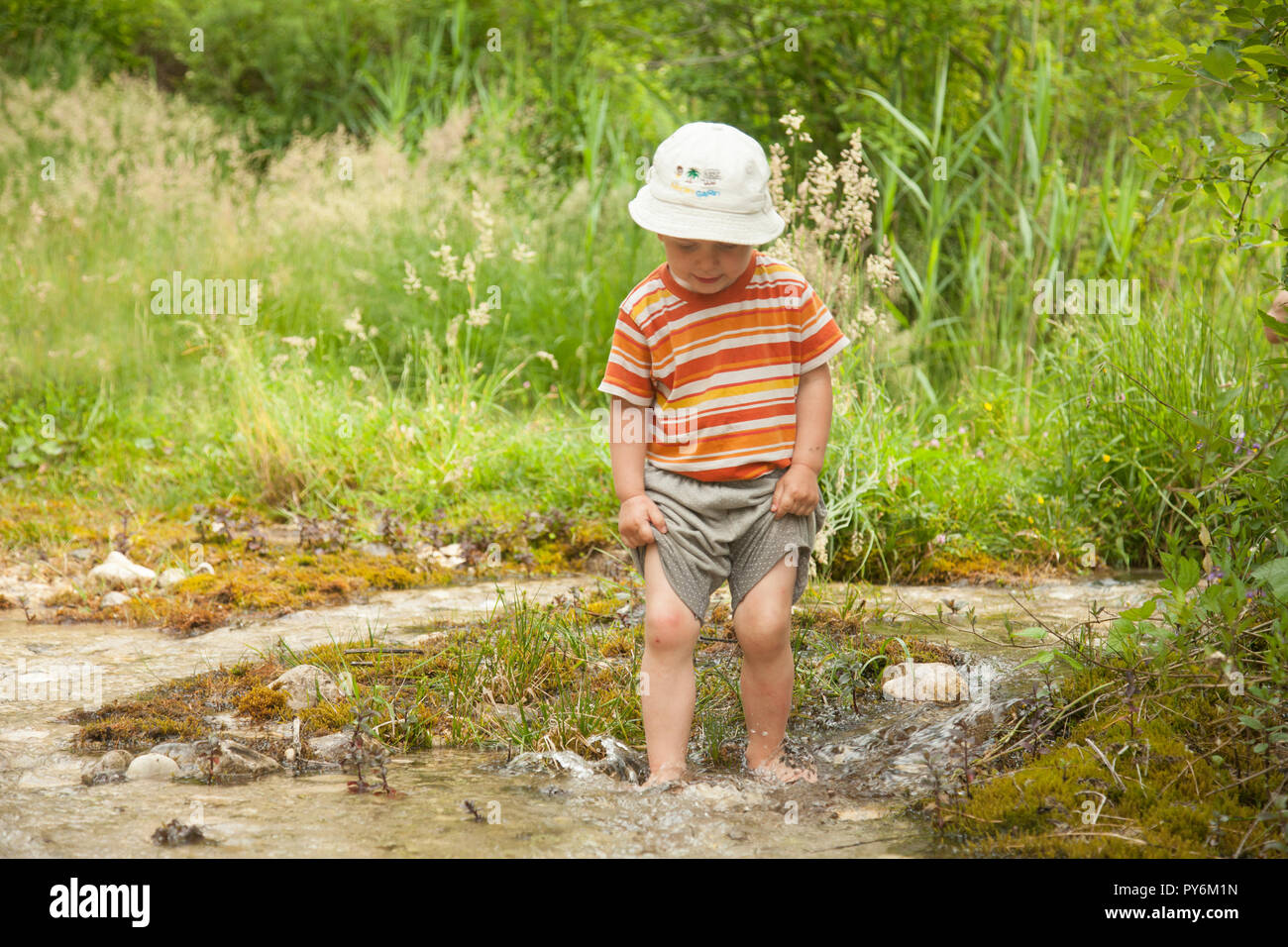 Little baby playing in stream Stock Photo - Alamy
