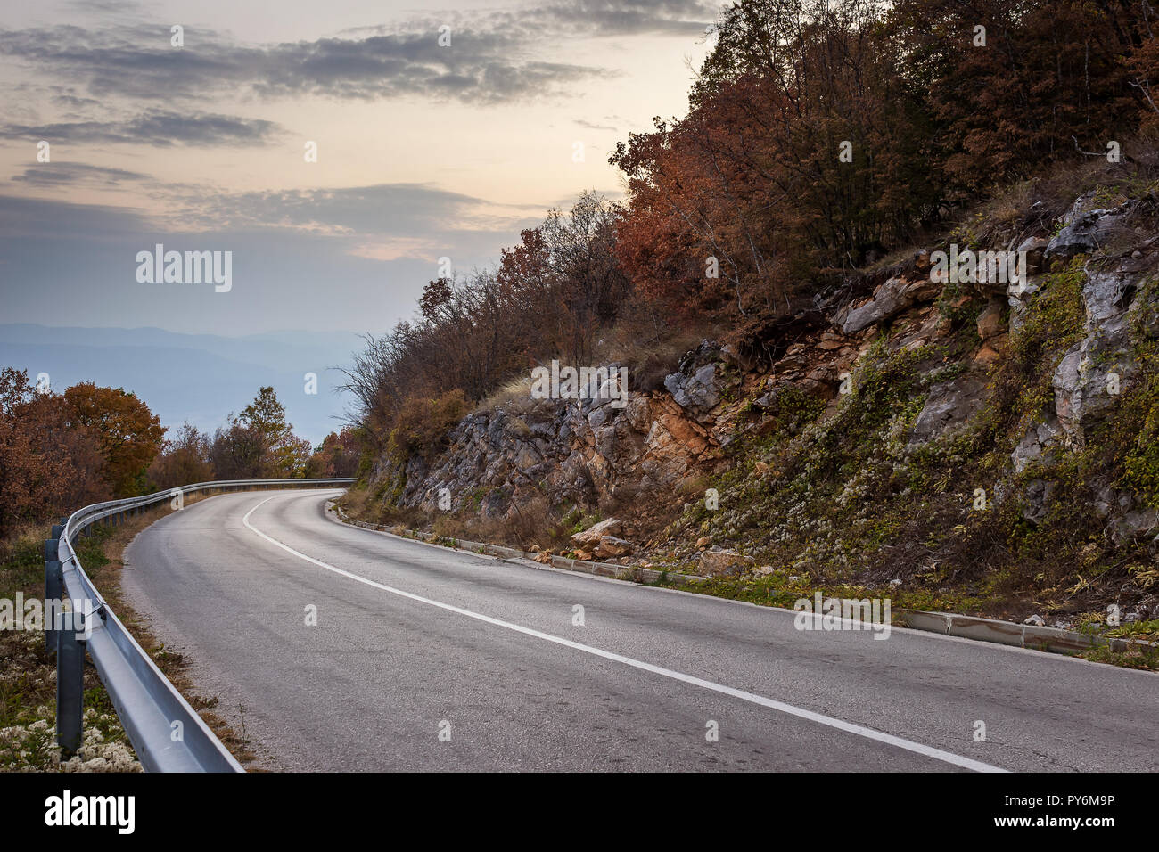 Curvy mountain road, autumn colors and beautiful sunset sky Stock Photo ...