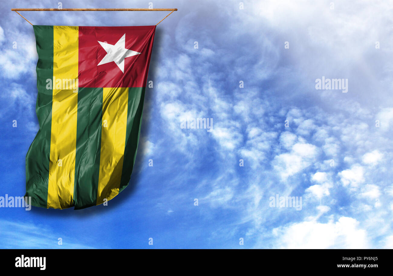 Flag of Togo. Vertical flag, against blue sky with place for your text Stock Photo - Alamy