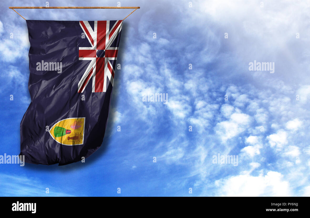 Flag of Turks and Caicos Islands. Vertical flag, against blue sky with ...