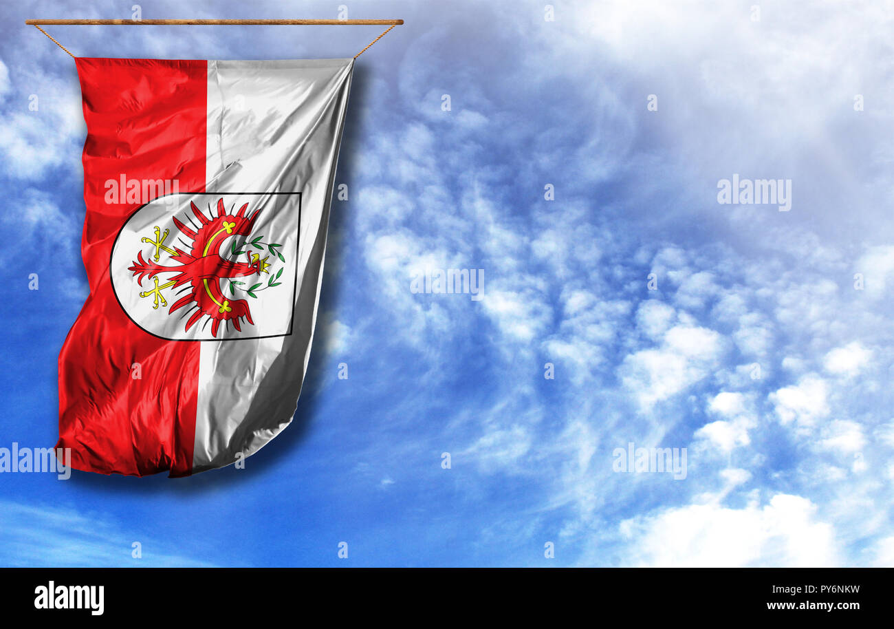 Flag of Tyrol . Vertical flag, against blue sky with place for your ...