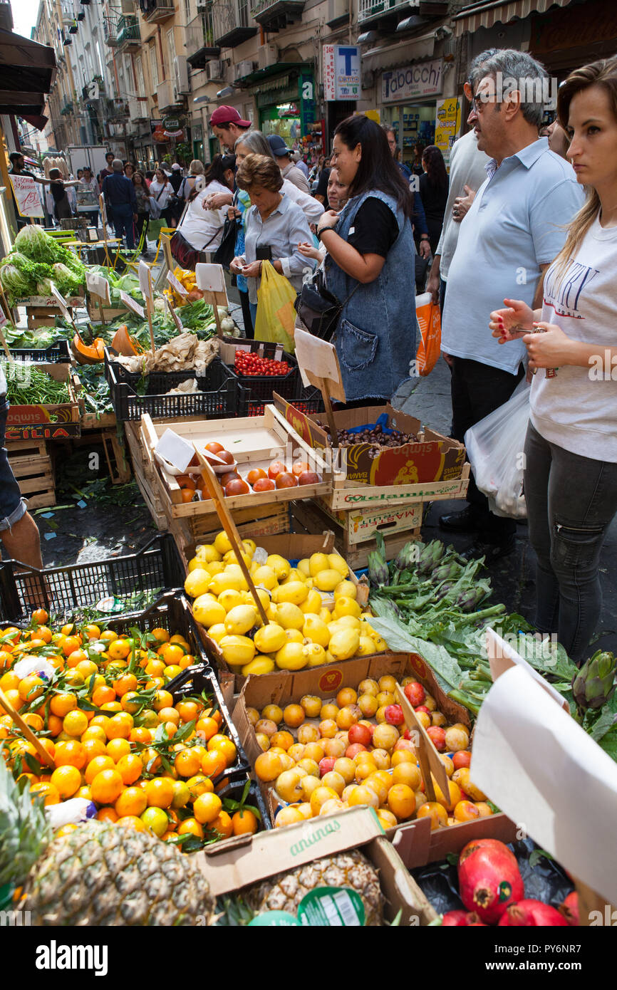 Customers at a fruit and vegetable stall in the historic centre of ...