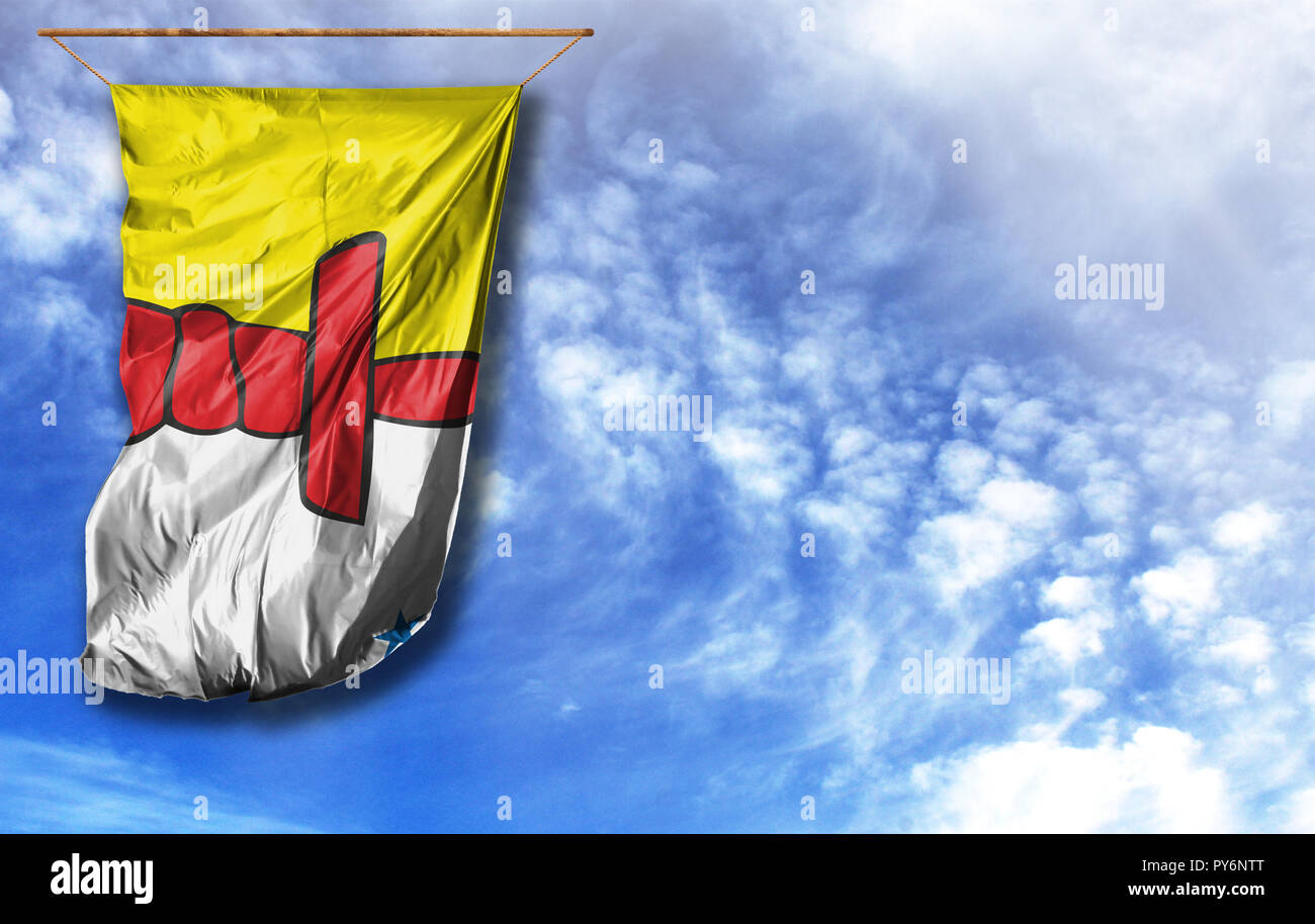 Flag of Nunavut. Vertical flag, against blue sky with place for your ...