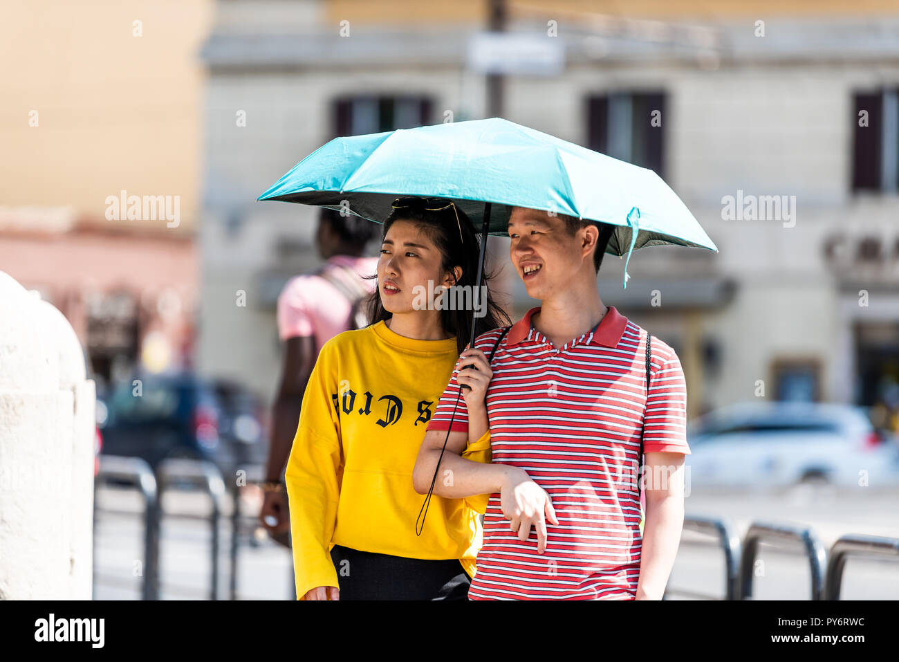 Woman walking under sun umbrella hi-res stock photography and images ...