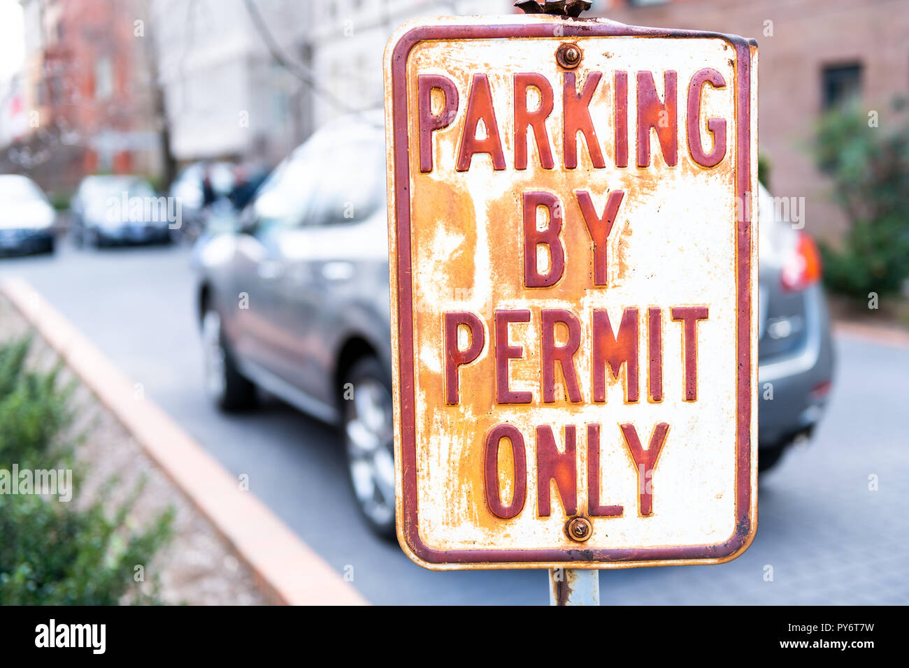 Parking by permit only street traffic sign outside, outdoors with many ...