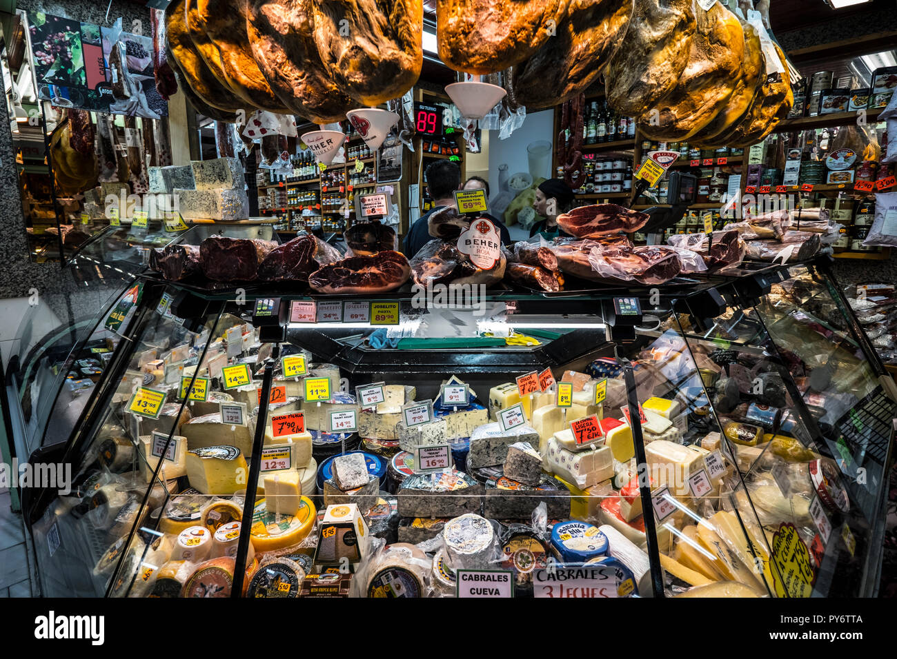 A large selection of different cheeses on the counter at the food ...