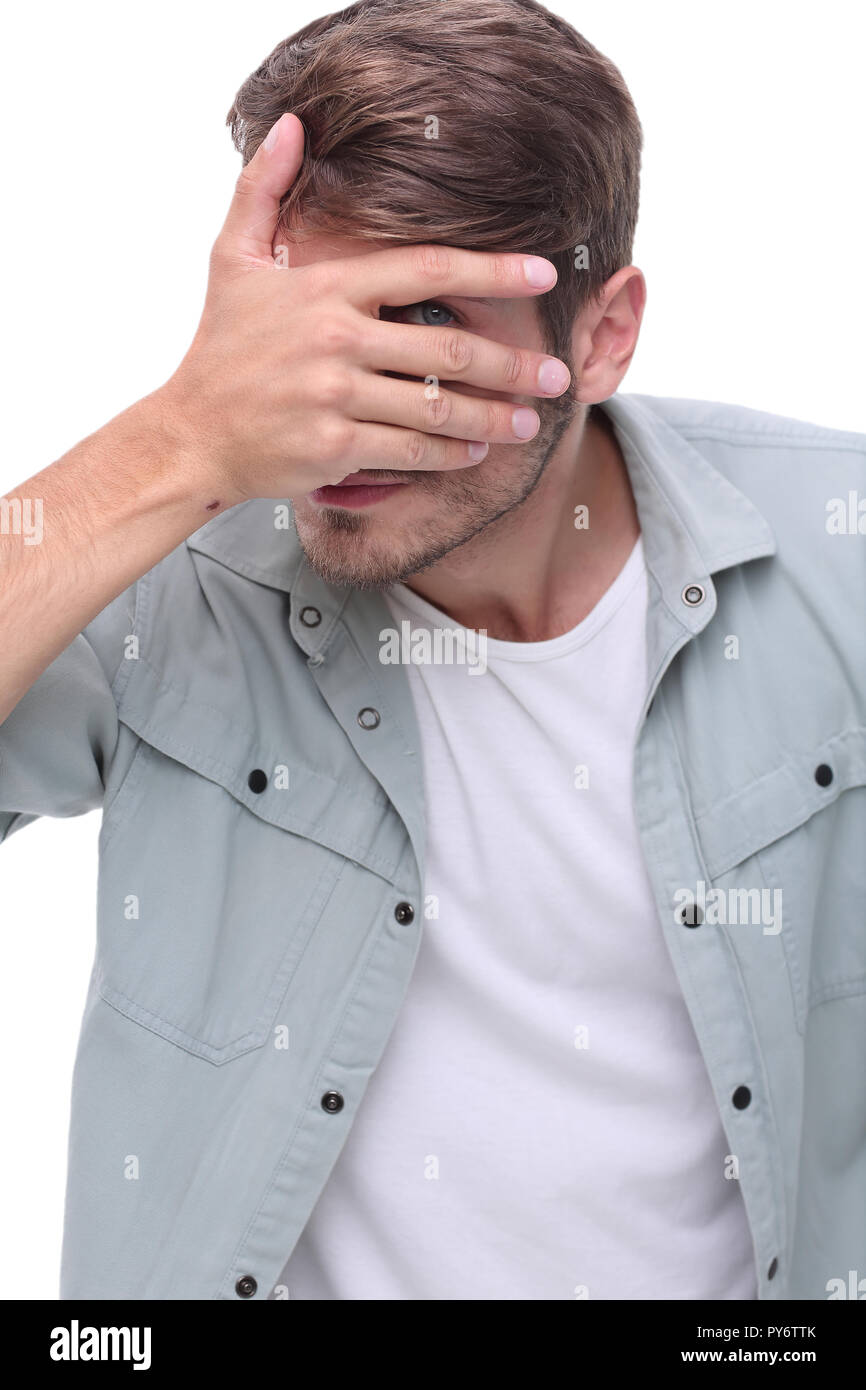 close up.young man covering his face with his hands Stock Photo - Alamy
