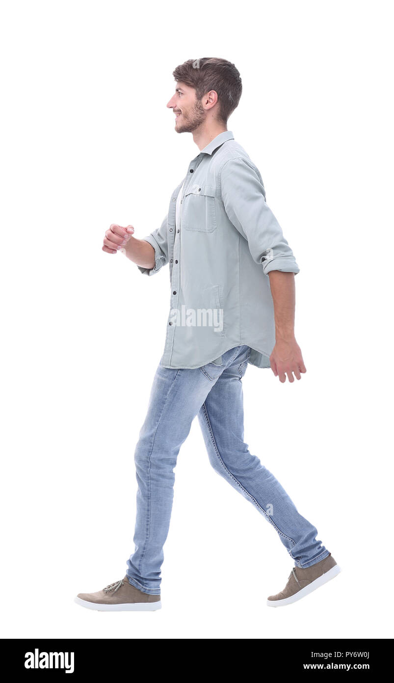 side view. a smiling young man steps forward Stock Photo - Alamy