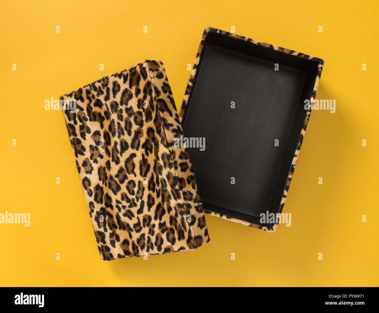 Storage box with classic leopard print, on bright yellow background ...