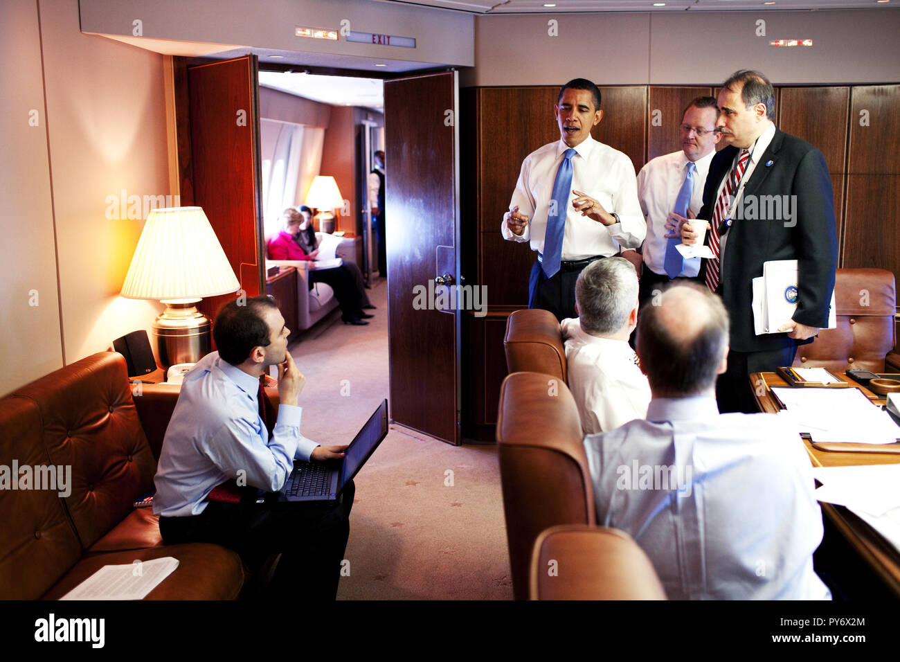 President Barack Obama meets with staff aboard Air Force One during ...
