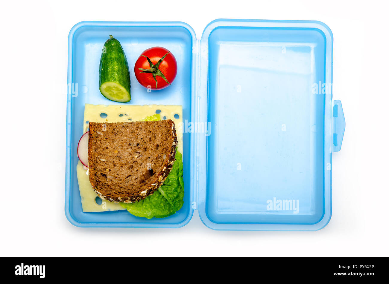 blue lunch box with bread and vegetables on white background, isolated ...