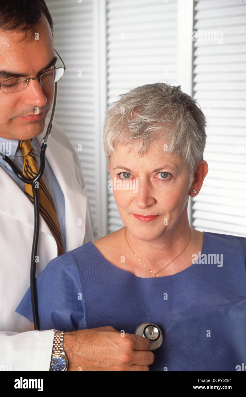 Doctor Monitoring Hear beat of Mature Female patient during a Office ...