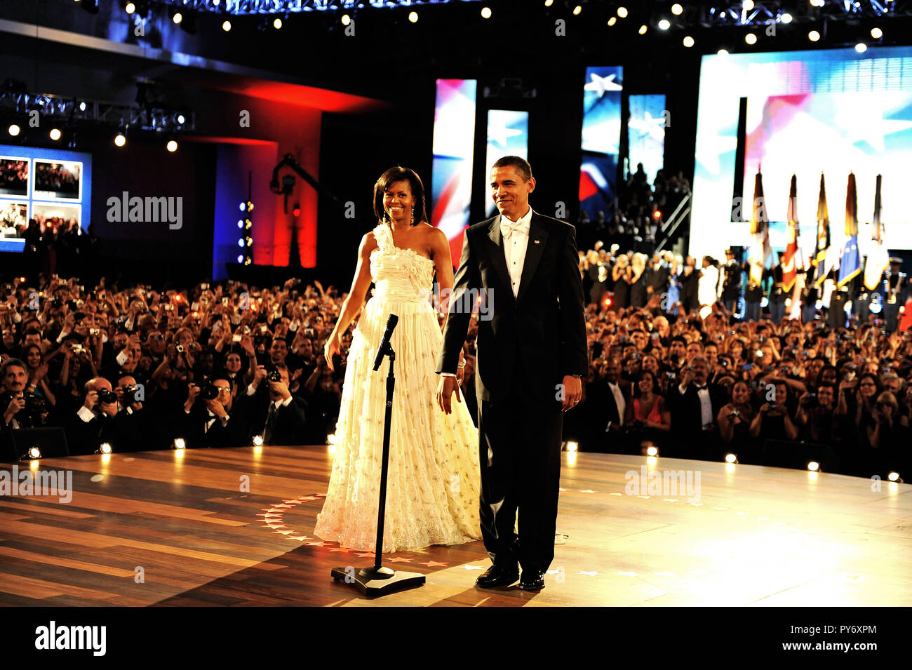 The crowd cheers as President Barack Obama and First Lady Michelle ...