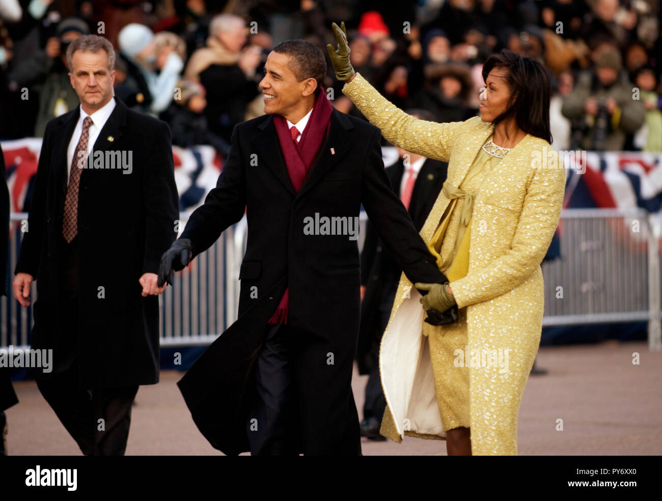 President Barack Obama and first lady Michelle Obama wave to the crowds ...