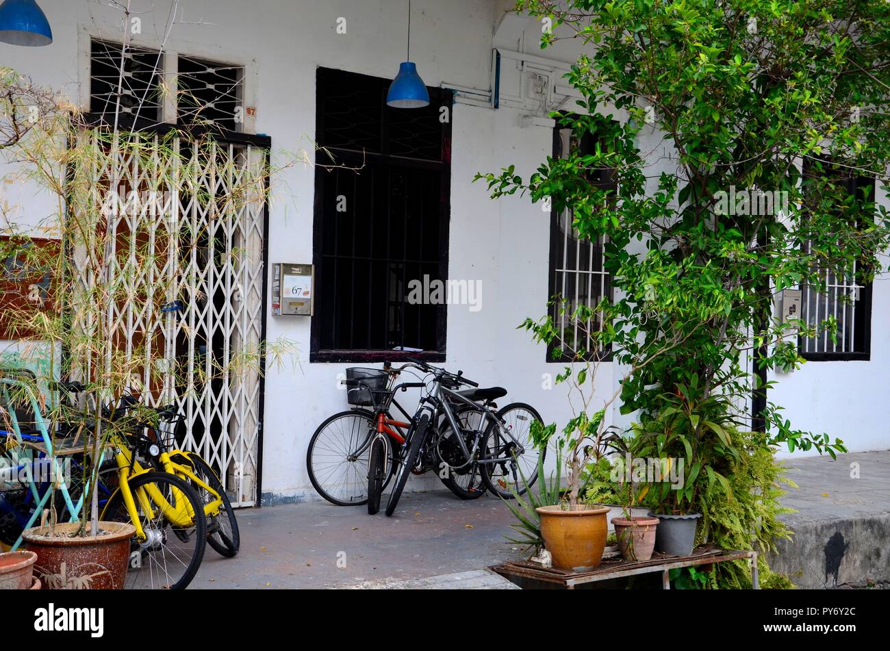 Old shop house with bicycles and windows on pavement Kampong Glam ...
