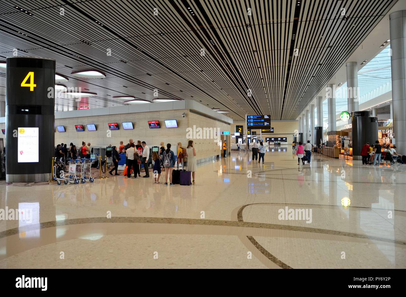 Passengers line up at self check in counters at Singapore Changi ...