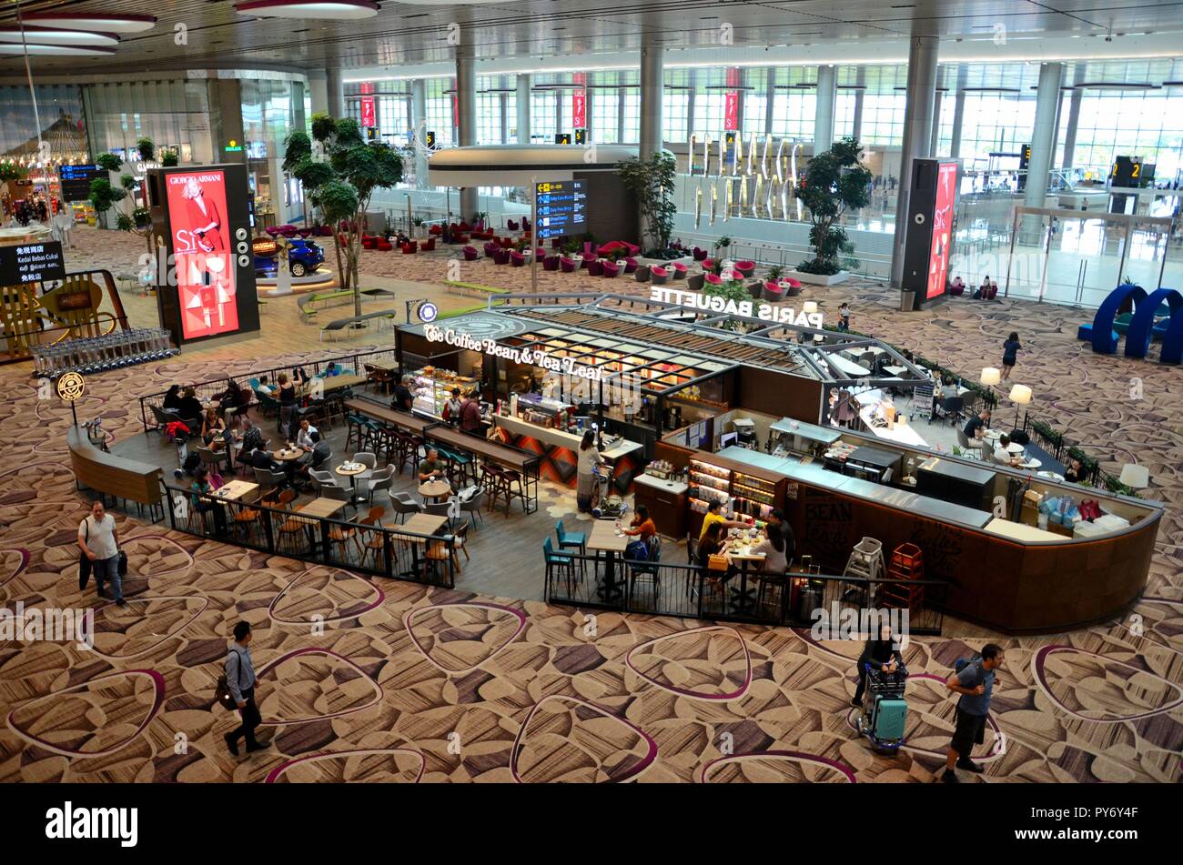 Travellers at cafe inside new terminal four at Singapore Changi Airport ...