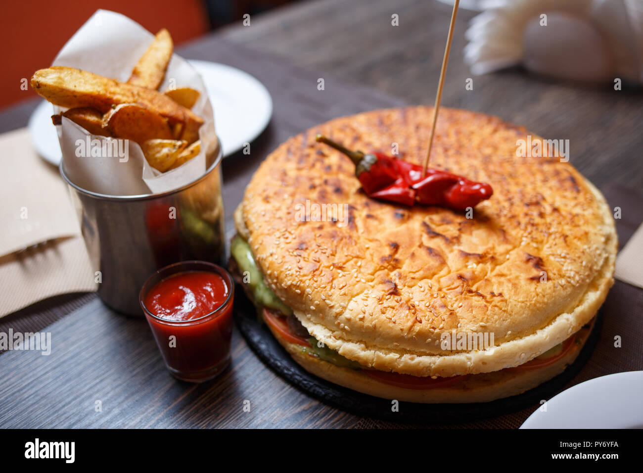 Golden potato wedges with big burger on the table in a restaurant Stock ...