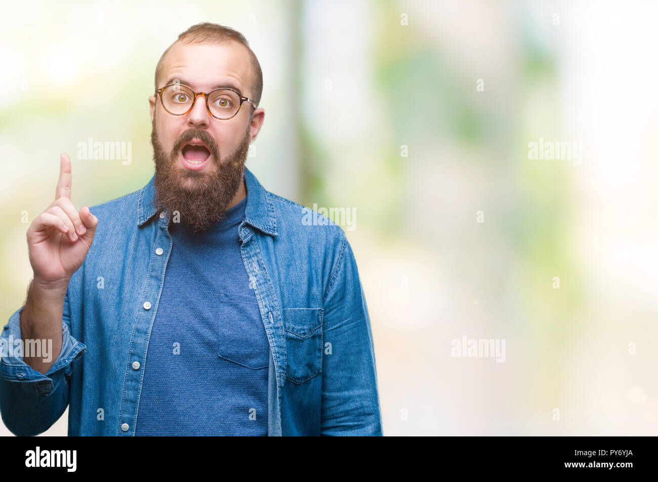 Young caucasian hipster man wearing glasses over isolated background ...
