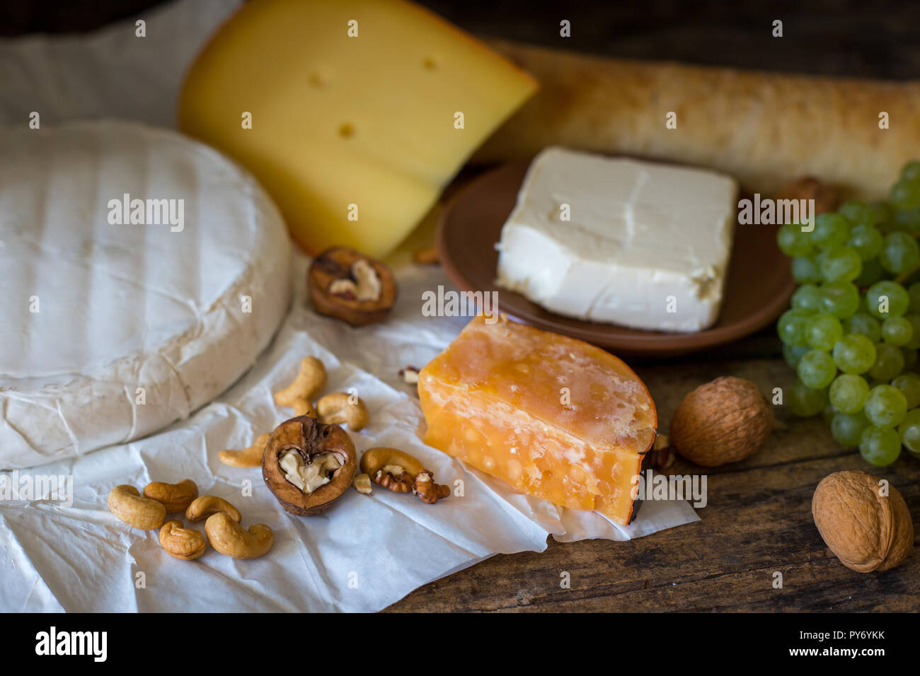 Variety of different cheese with nuts on the table Stock Photo - Alamy