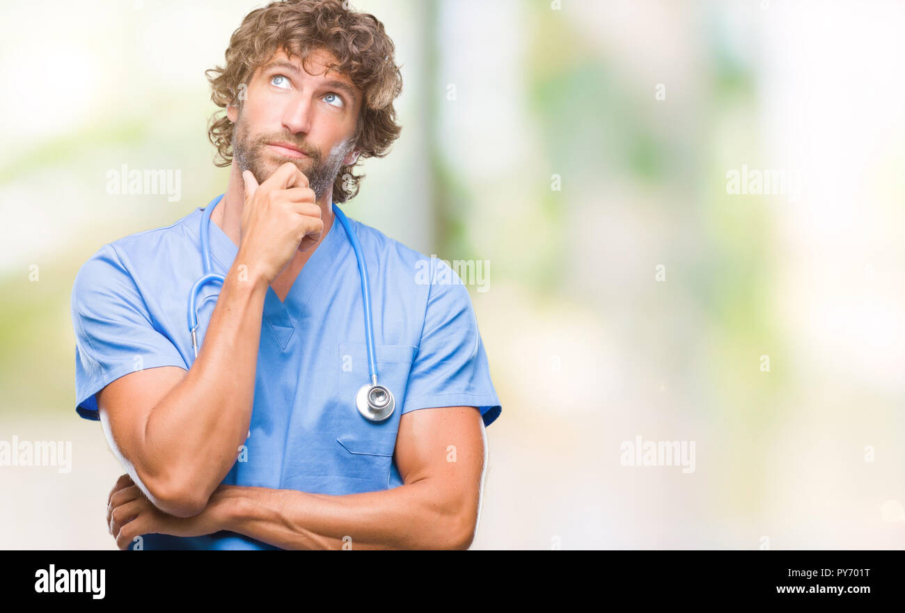 Handsome hispanic surgeon doctor man over isolated background with hand ...