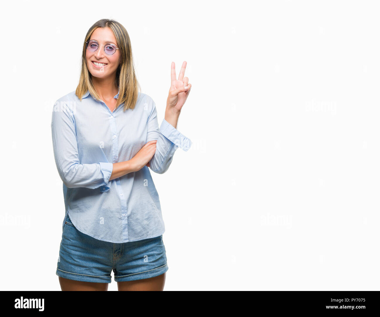 Young beautiful woman wearing sunglasses over isolated background ...