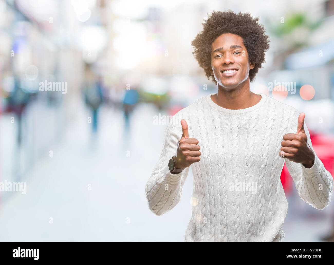 Afro american man over isolated background success sign doing positive ...