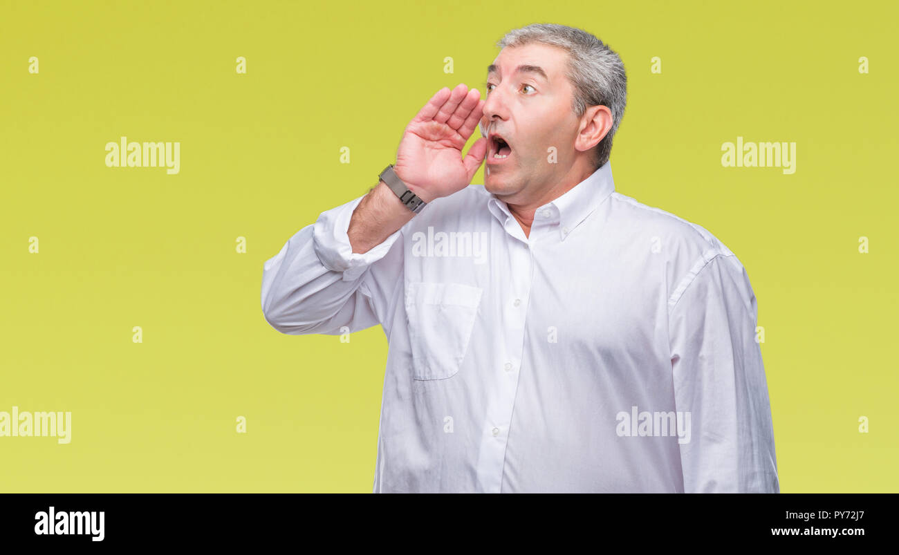 Handsome senior man over isolated background shouting and screaming ...