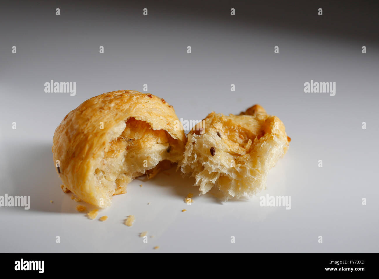 Smashed, isolated salted croissant with sesamo Stock Photo - Alamy