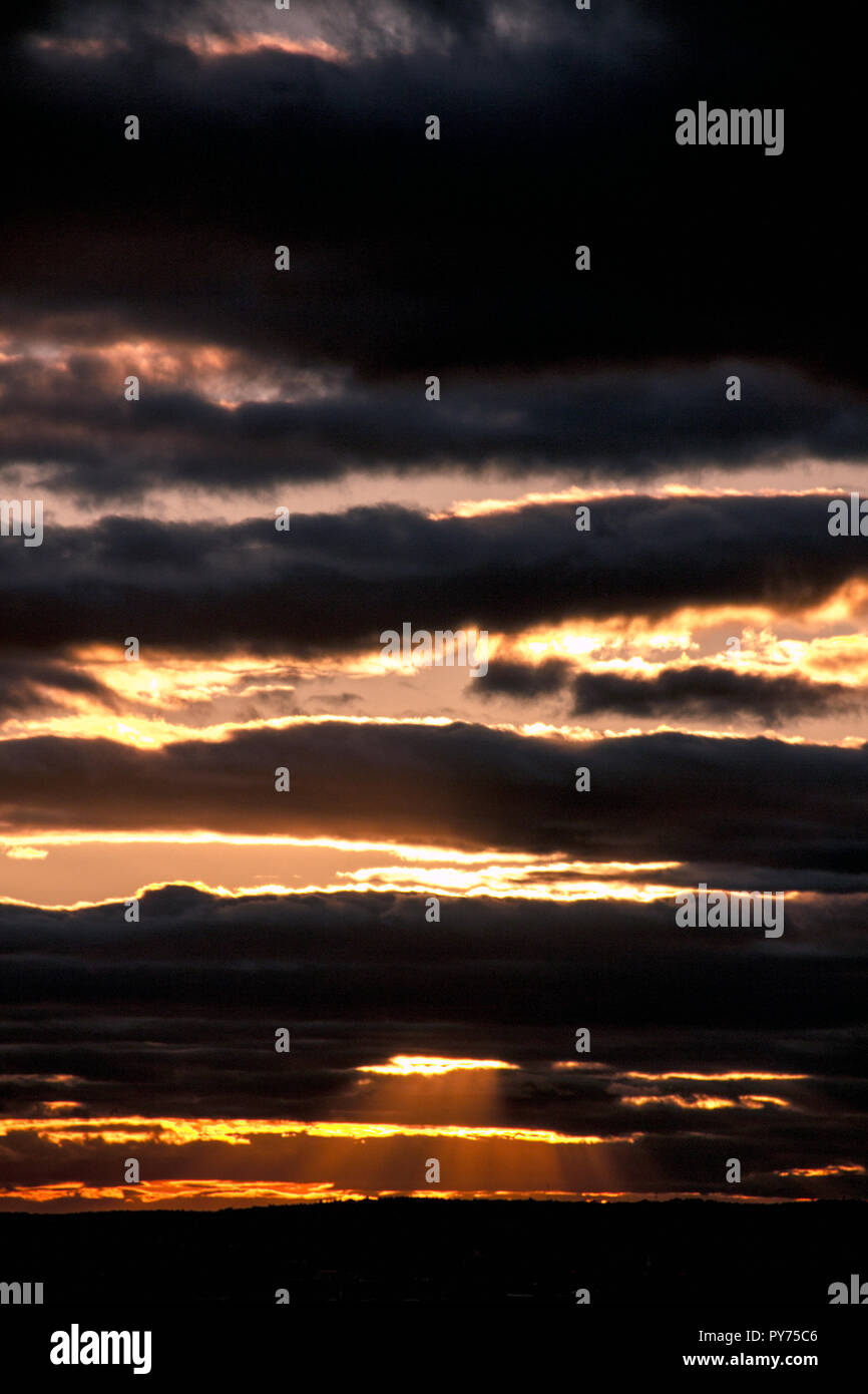 Sunset sky, sun behind the clouds Stock Photo - Alamy