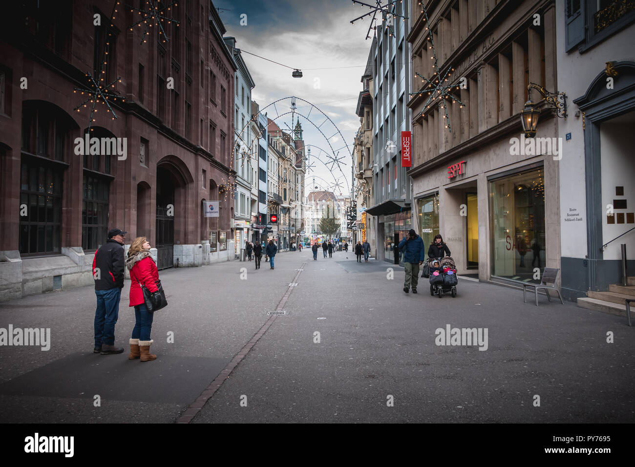 Basel, Switzerland - December 25, 2017 - People dressed warmly walk the ...