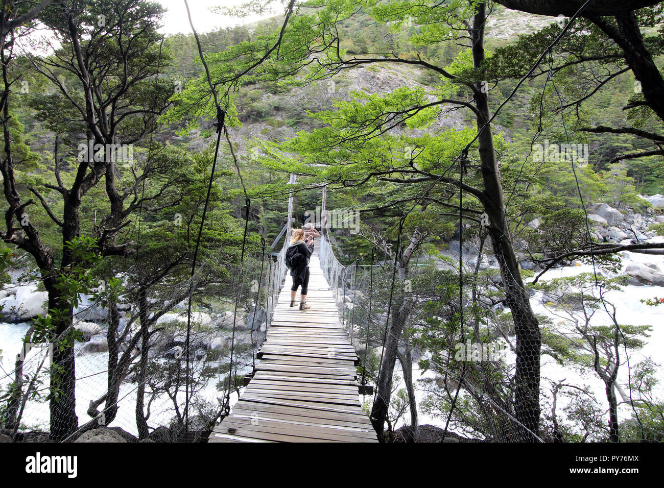 Wooden foot bridge suspended across the river near the Italian ...
