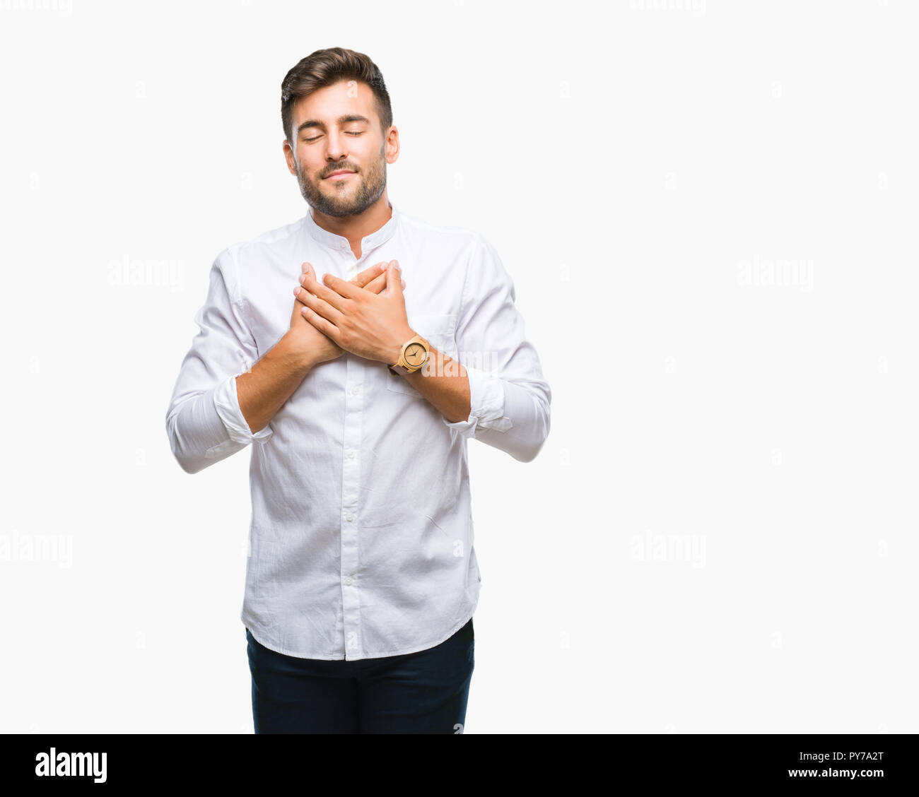 Young handsome man over isolated background smiling with hands on chest ...