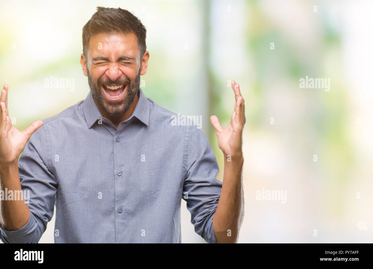 Adult hispanic man over isolated background celebrating mad and crazy ...