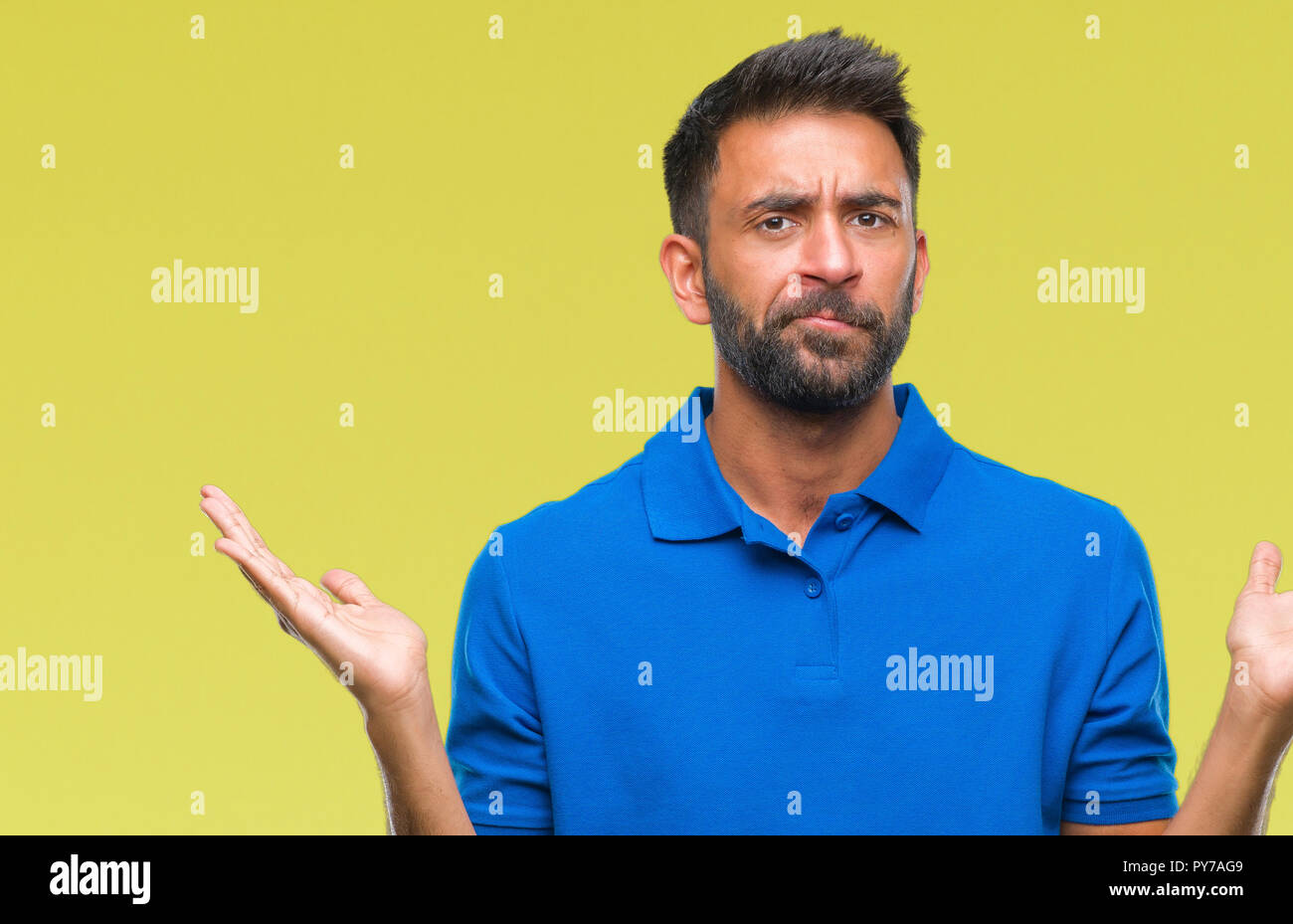 Adult hispanic man over isolated background clueless and confused ...