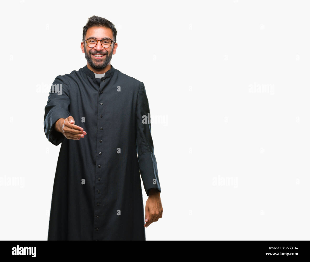 Adult hispanic catholic priest man over isolated background smiling ...