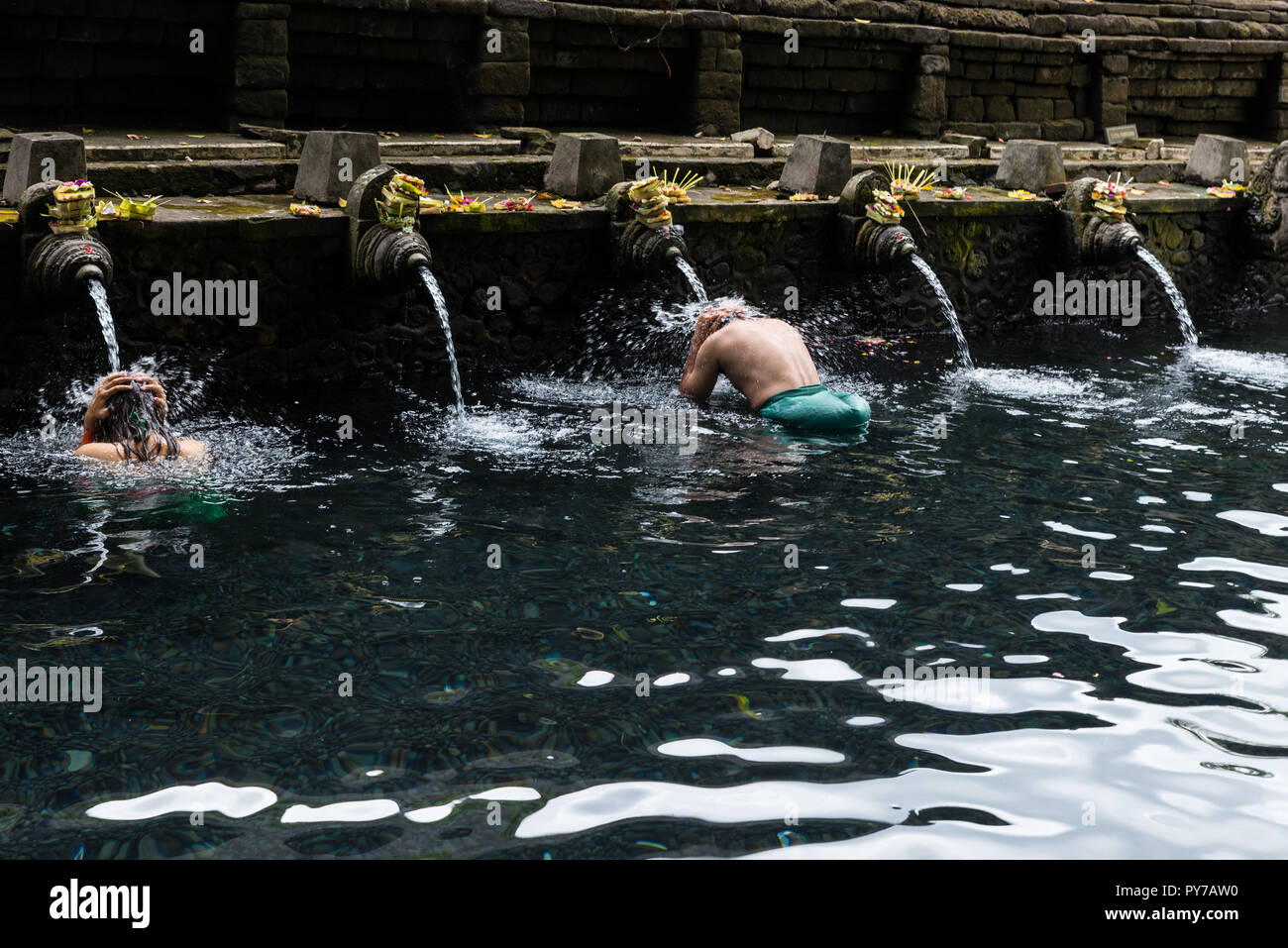 People bathing in the waters of the Tirta Empul Water Temple, Ubud ...