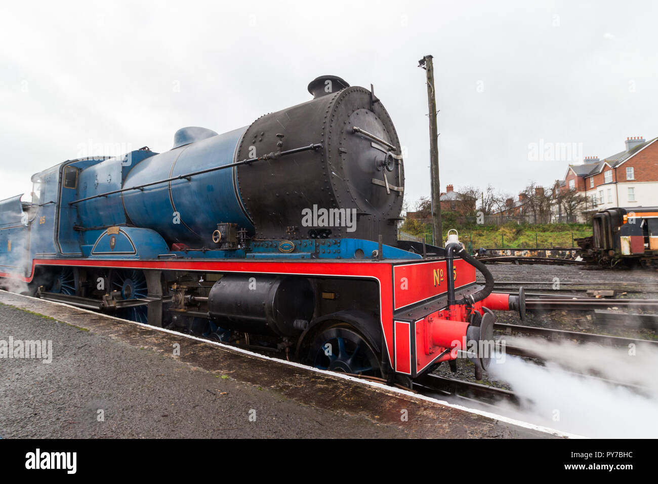 Blue steam train reversing letting off steam. Whitehead station, County ...